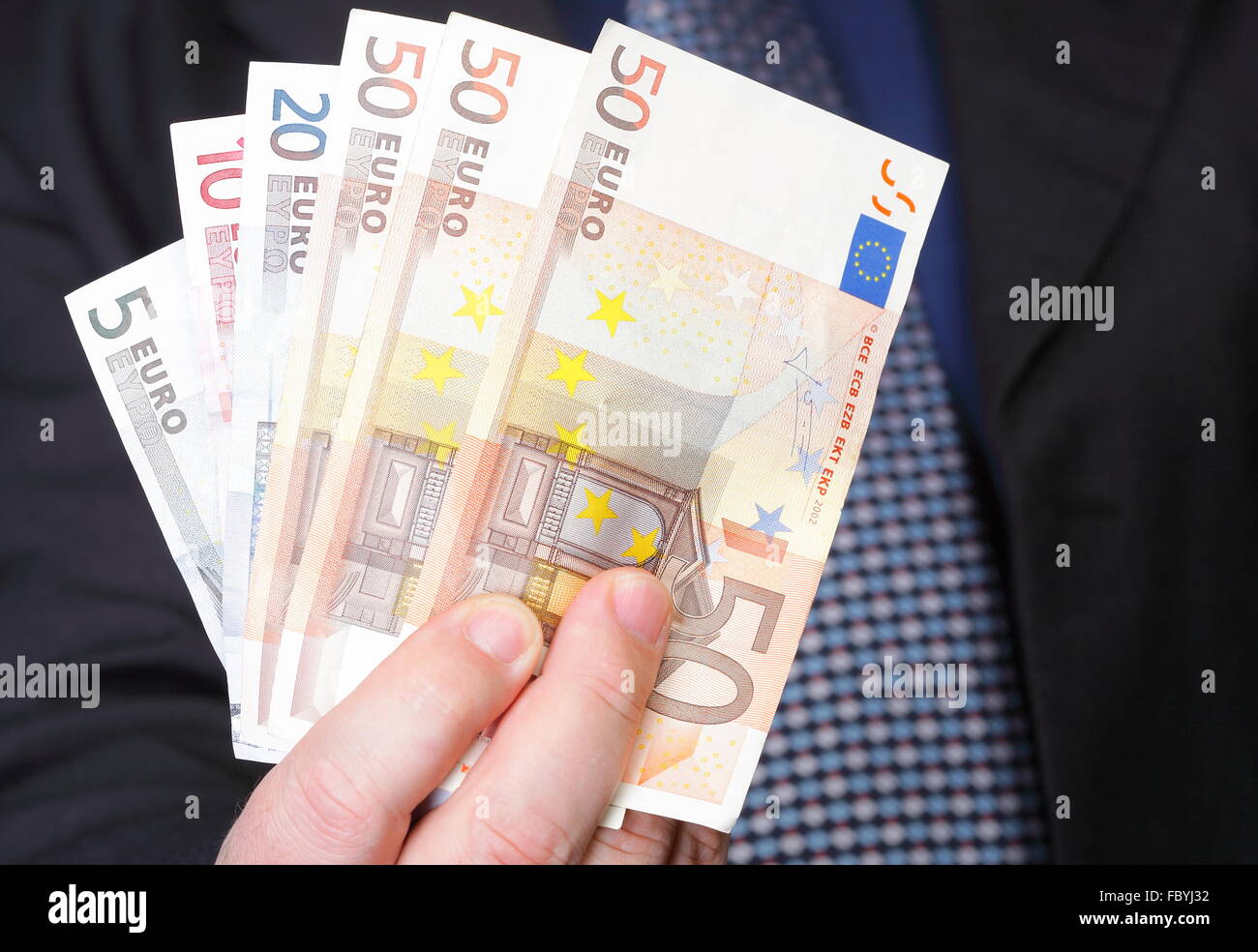 Euro banknotes in male hand Stock Photo - Alamy