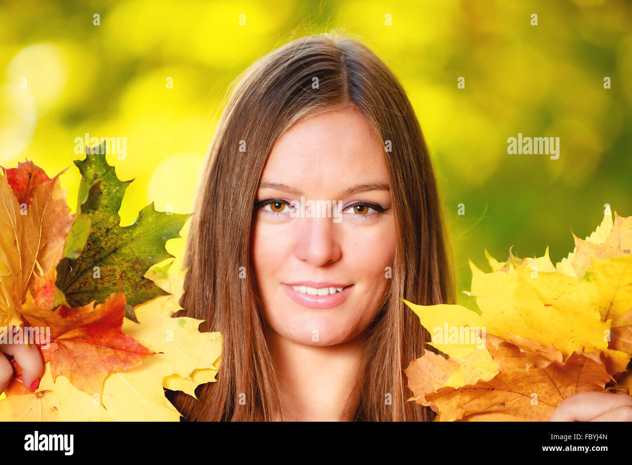Fall season. Portrait girl woman holding autumnal leaves in park Stock ...