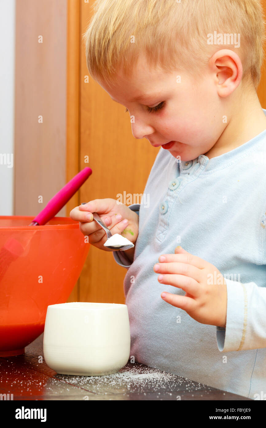 Boy kid baking cake. Child with teaspoon and sugar bowl. Kitchen Stock ...