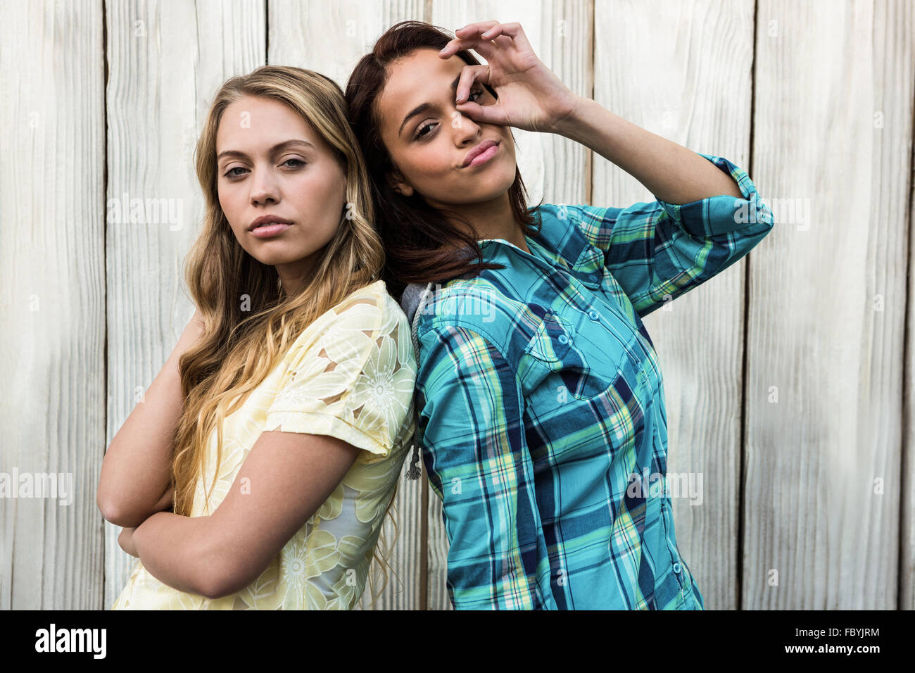 Two friends making posing and making gesture Stock Photo - Alamy