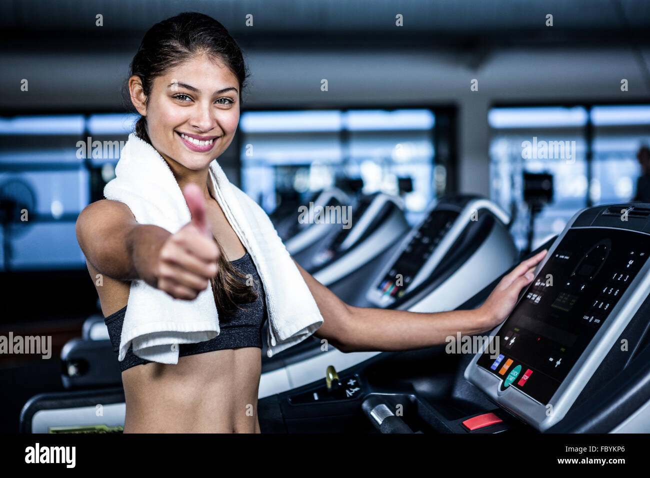 Smiling fit woman showing thumbs up Stock Photo - Alamy