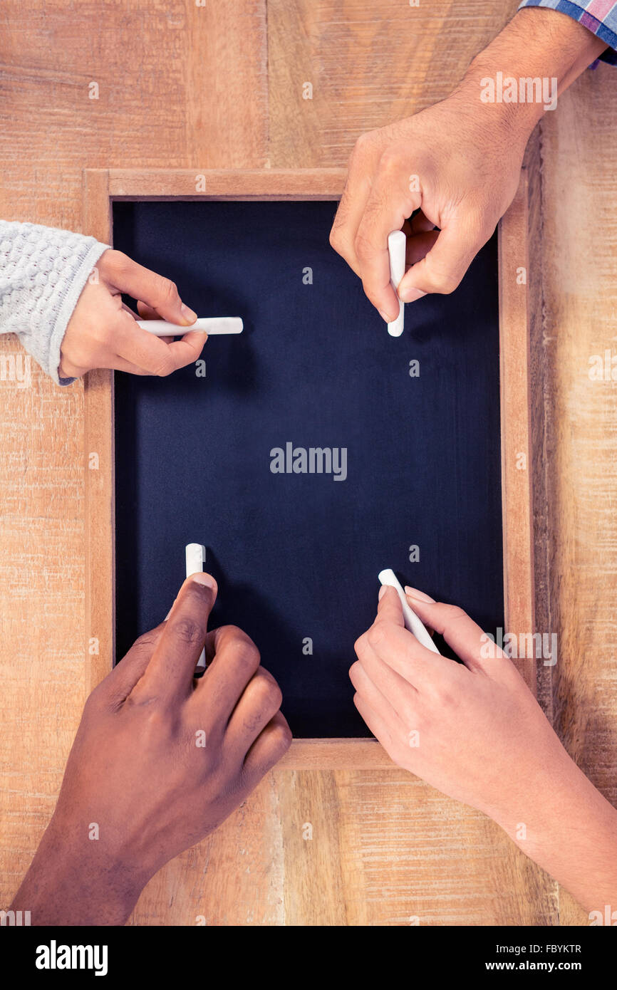 Cropped hands writing on slate Stock Photo - Alamy
