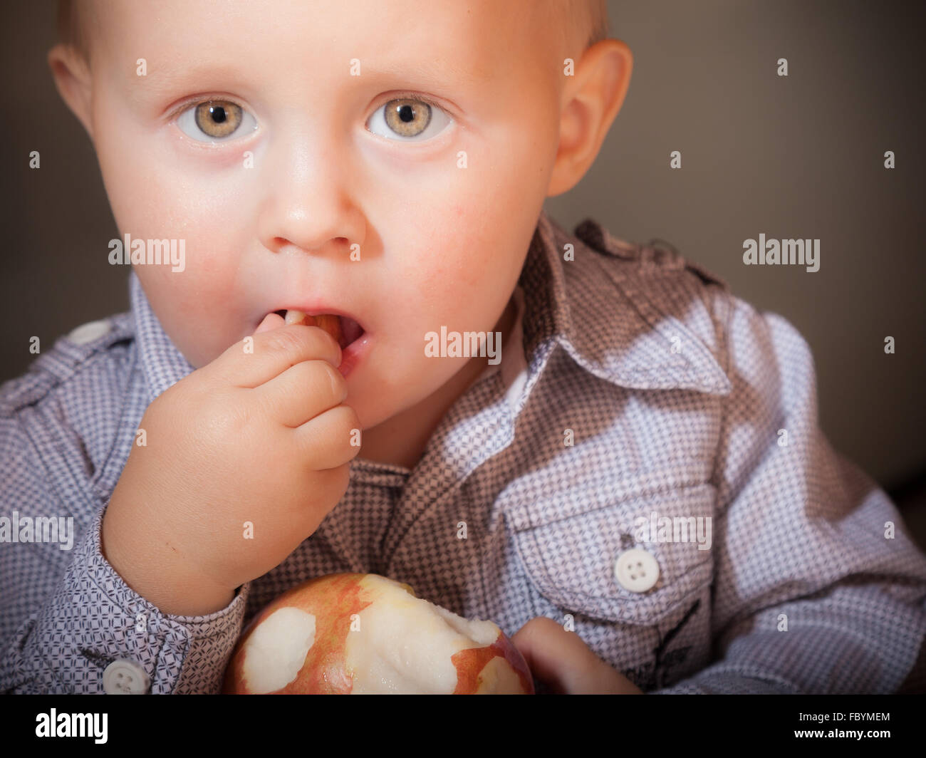 Boy biting into an apple hi-res stock photography and images - Alamy