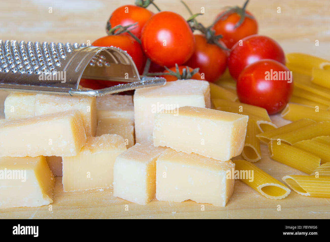 Italian grana padano with pasta and tomatoes Stock Photo - Alamy