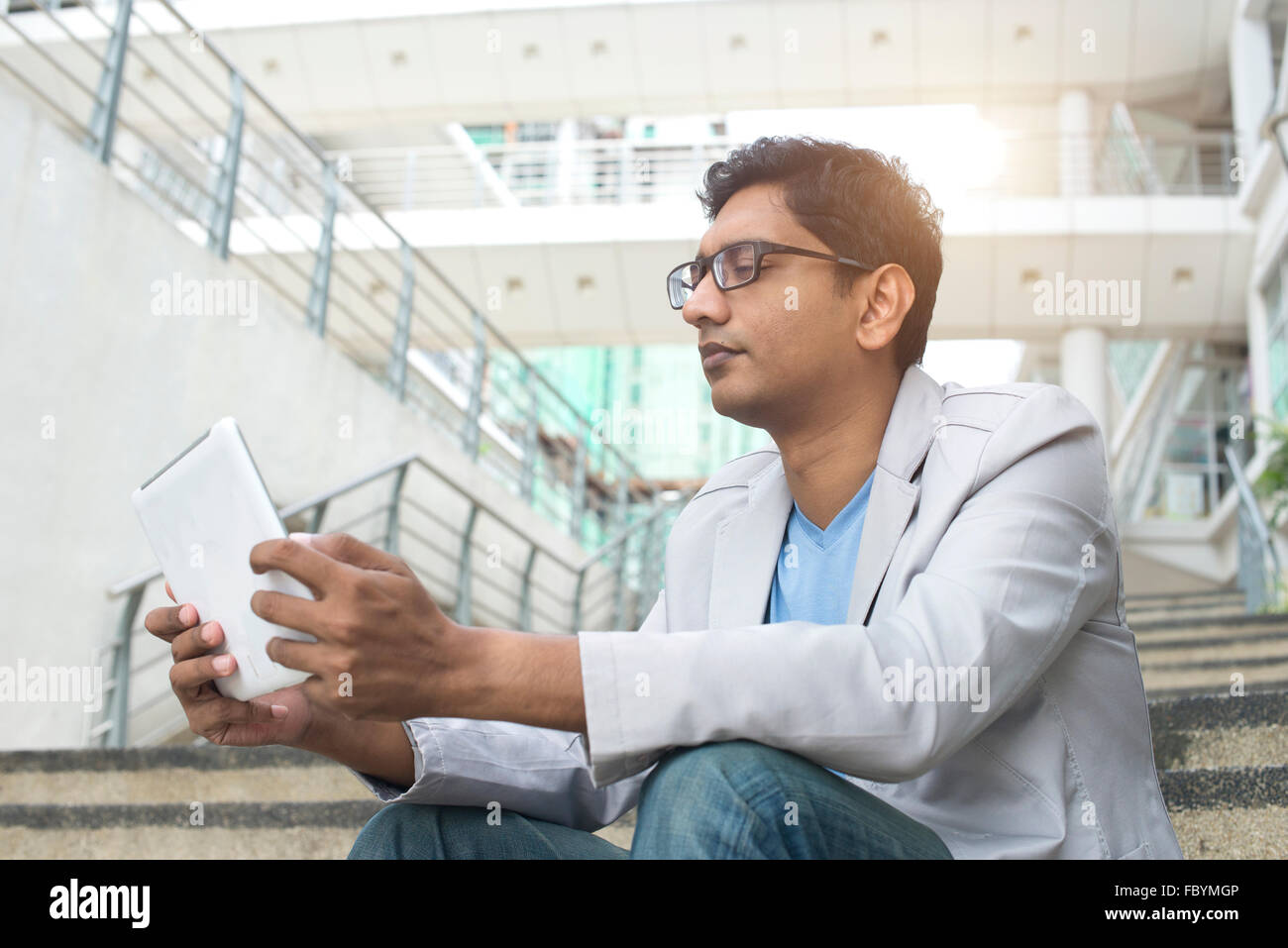 indian male using tablet outdoor Stock Photo - Alamy