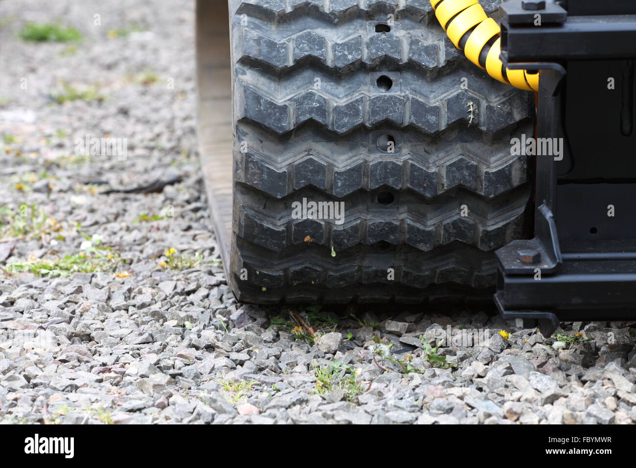 Tracks of small digger excavator Stock Photo - Alamy