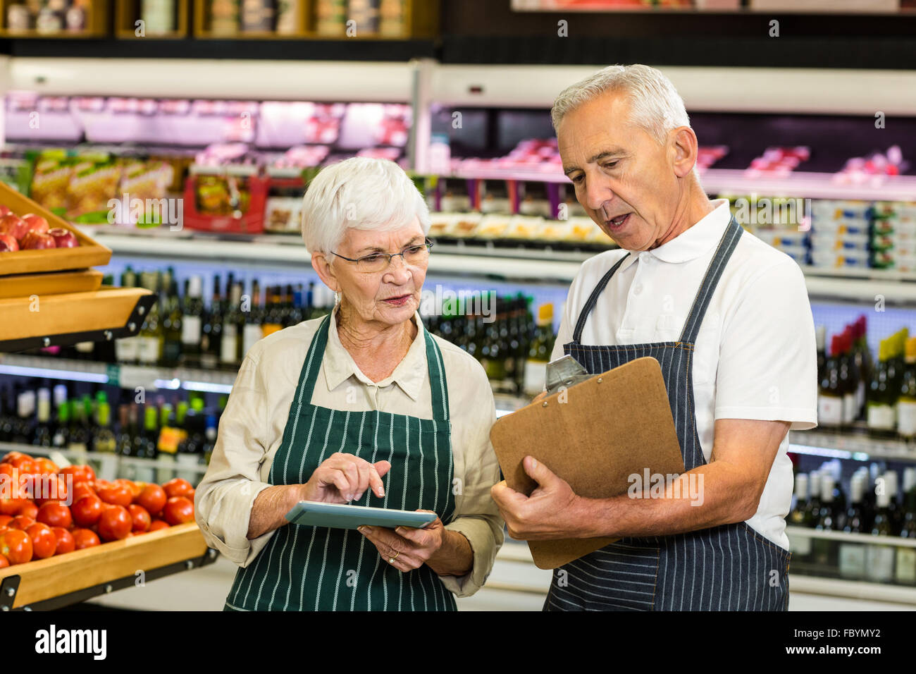 Senior colleagues with clipboard working Stock Photo - Alamy