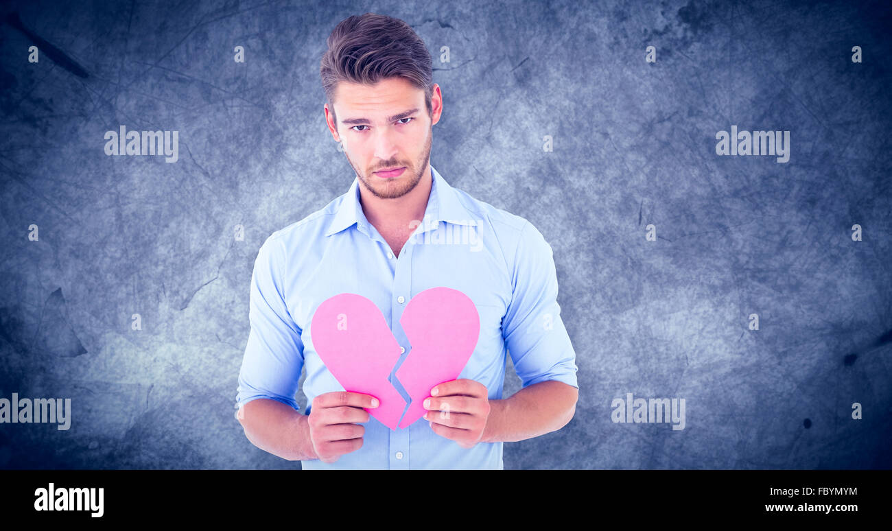 Composite image of sad man holding a broken heart Stock Photo - Alamy