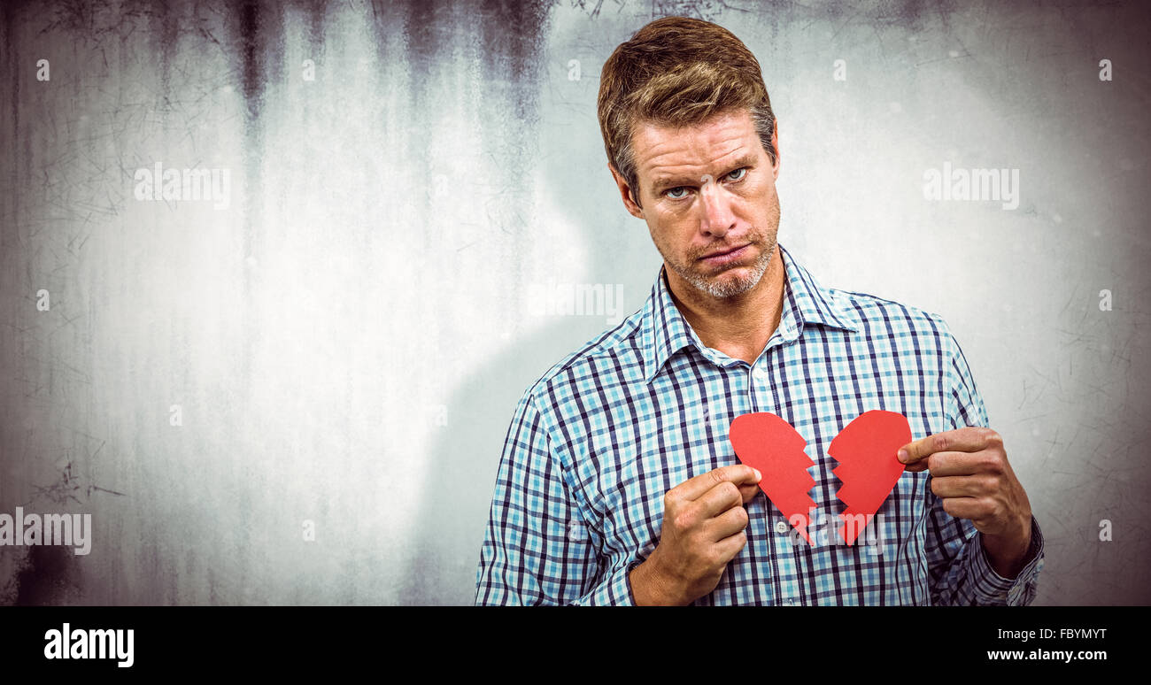 Composite image of sad man with broken heart Stock Photo - Alamy