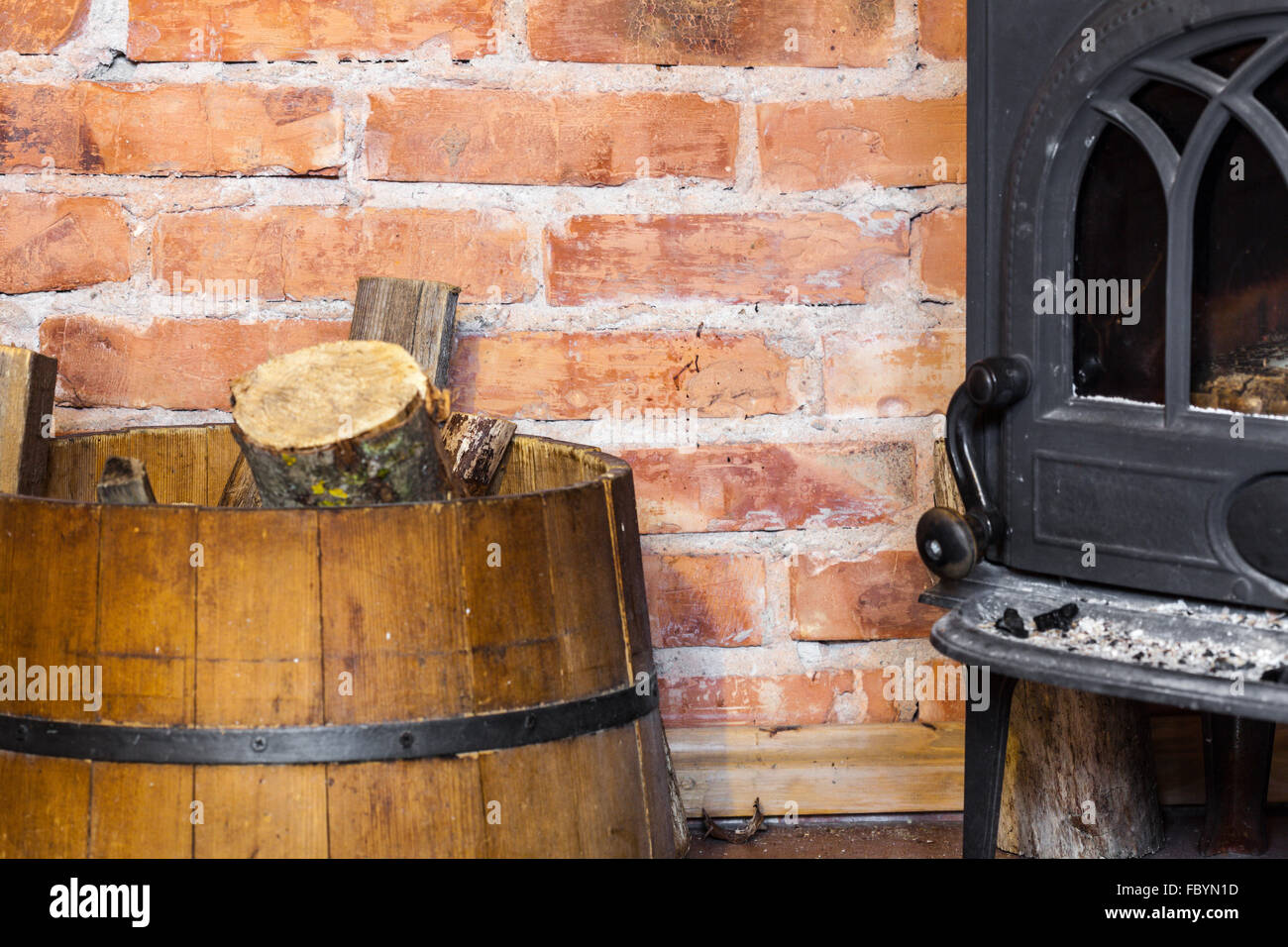 Fireplace with fire flame and firewood in barrel interior. Heating ...
