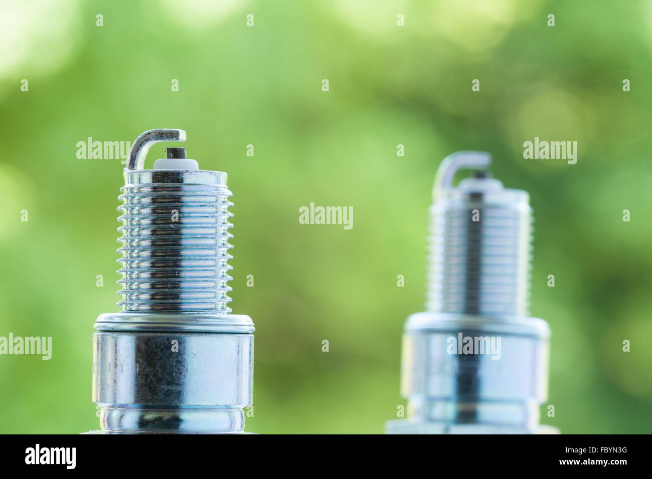 Auto service. Two new spark plugs as spare part of car Stock Photo - Alamy