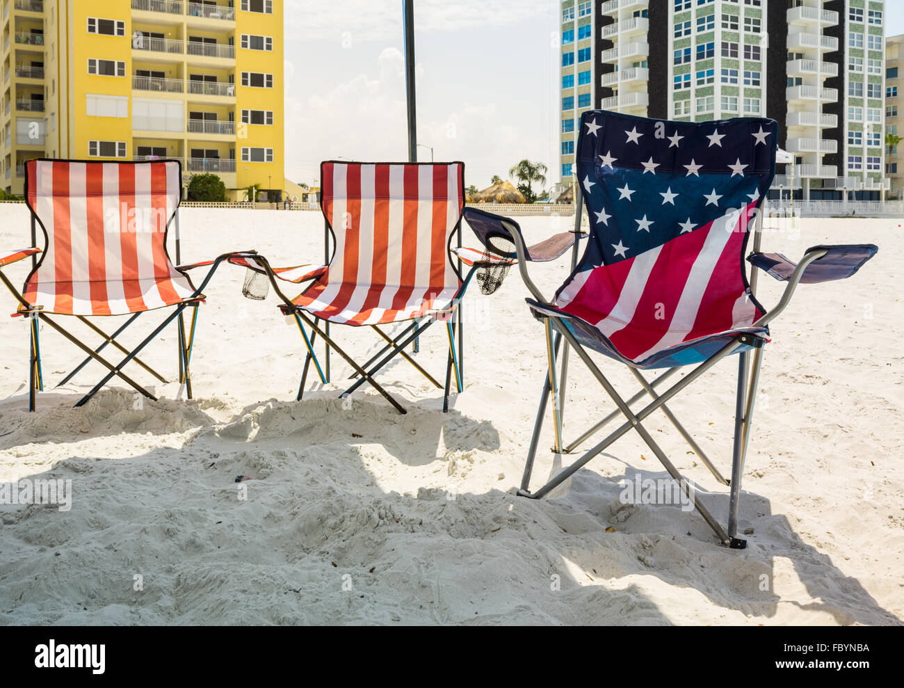 Three folding beach chairs under shade on beach Stock Photo - Alamy