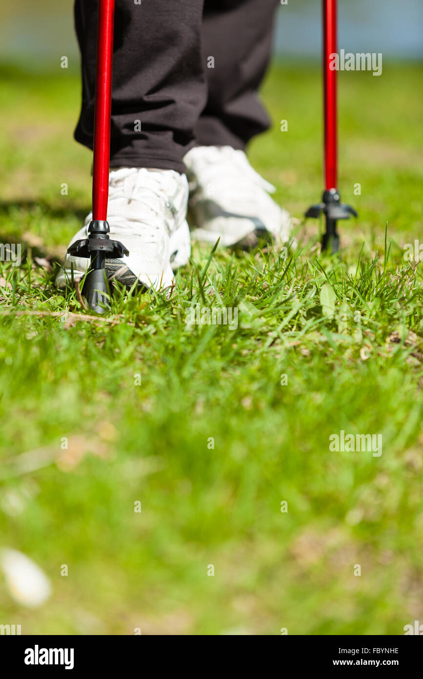 Nordic walking. Female legs hiking in the park Stock Photo - Alamy