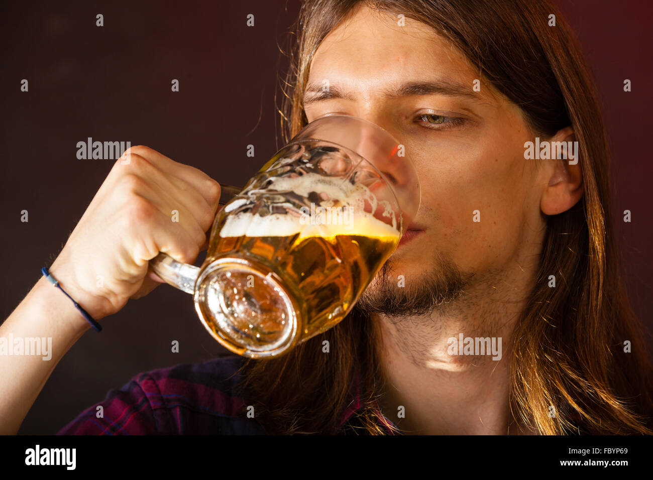 Young man drinking beer hi-res stock photography and images - Alamy