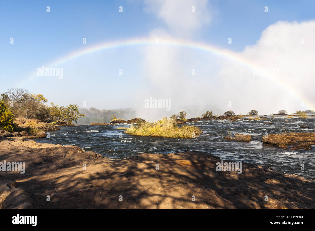 Rainbow Over Victoria Falls Stock Photo - Alamy