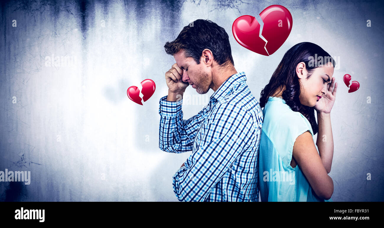 Composite image of depressed couple standing back to back Stock Photo ...
