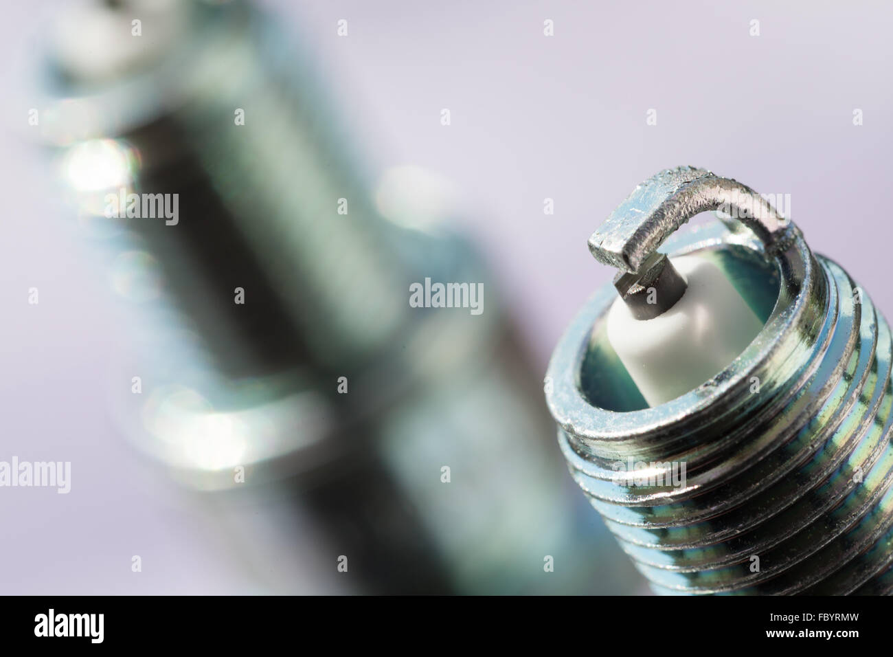 Auto service. Two new spark plugs as spare part of car Stock Photo - Alamy