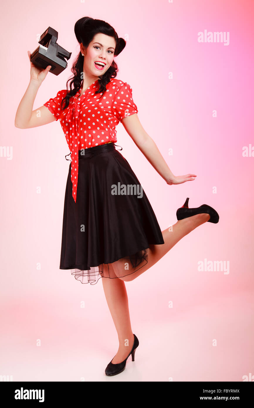 Retro. Pinup girl taking photo with vintage camera Stock Photo - Alamy