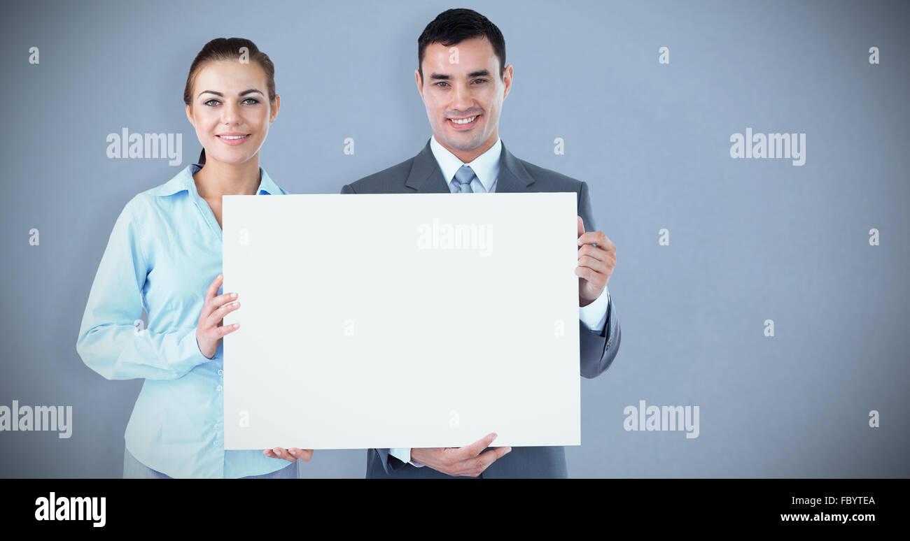 Composite image of business partners presenting sign Stock Photo - Alamy