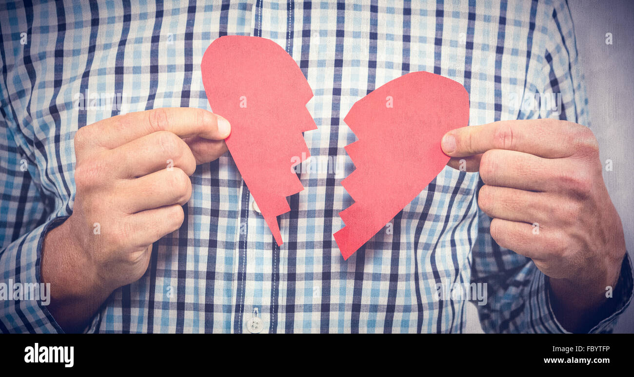 Composite image of sad man with broken heart Stock Photo - Alamy