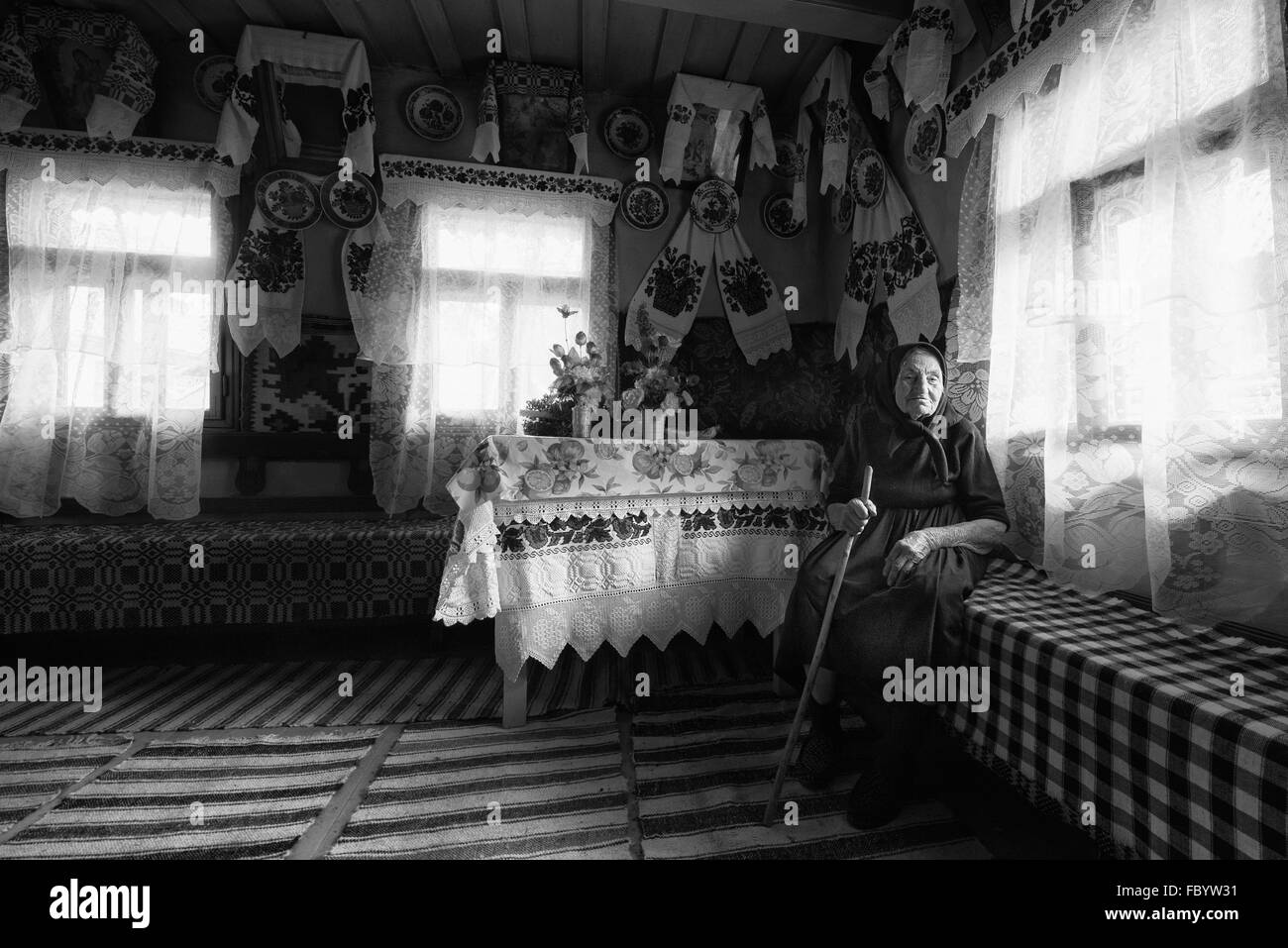 elderly woman sitting in their home in a village in the district of ...