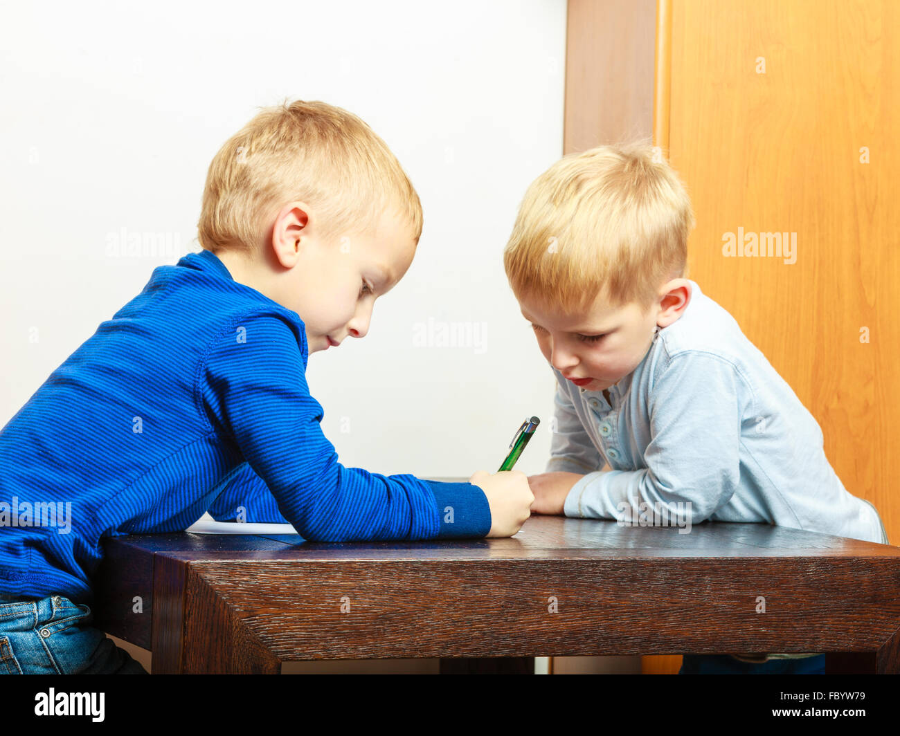 boys children with pen writing doing homework. At home Stock Photo - Alamy