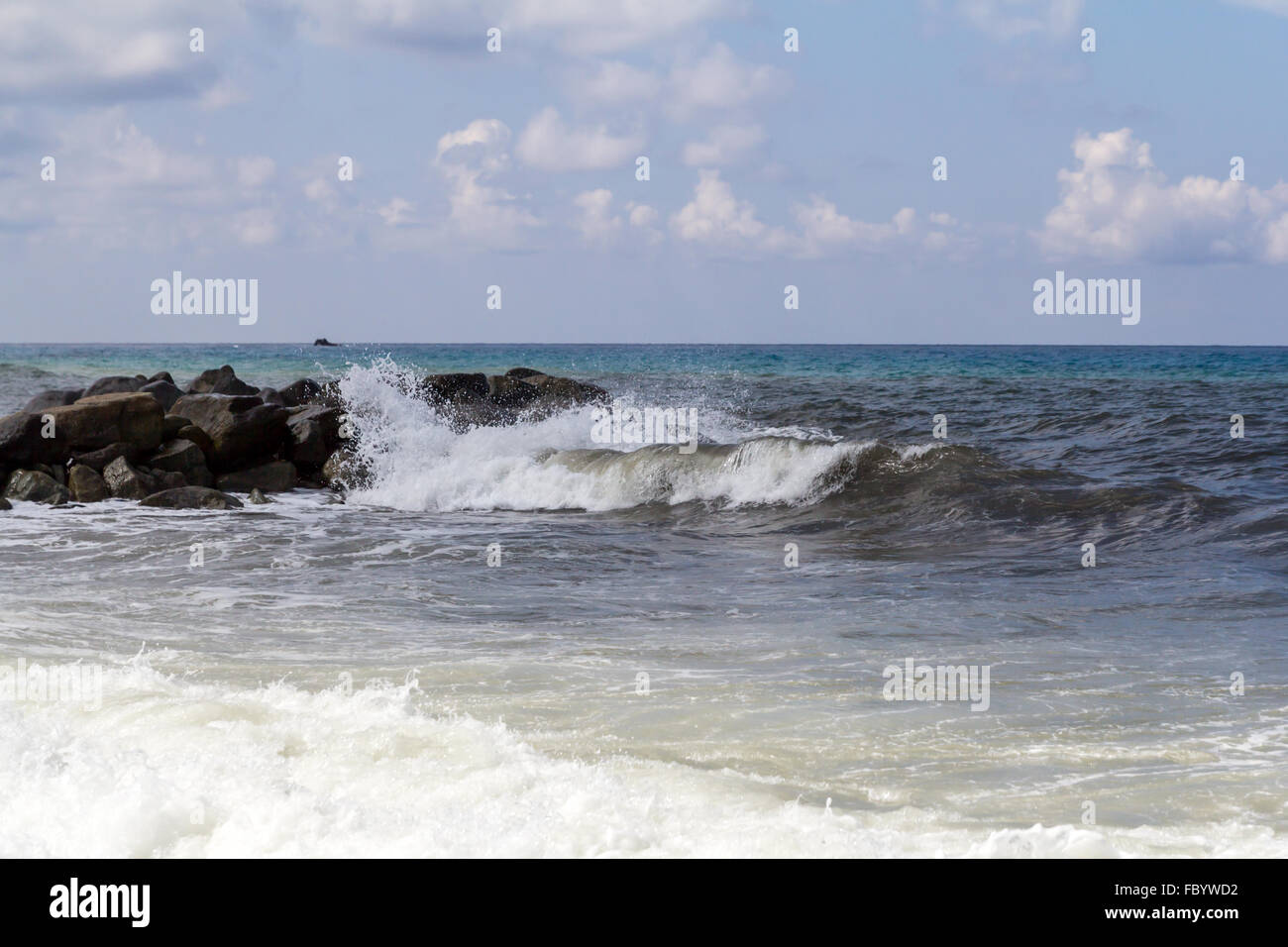 Rocks in the surge Stock Photo - Alamy