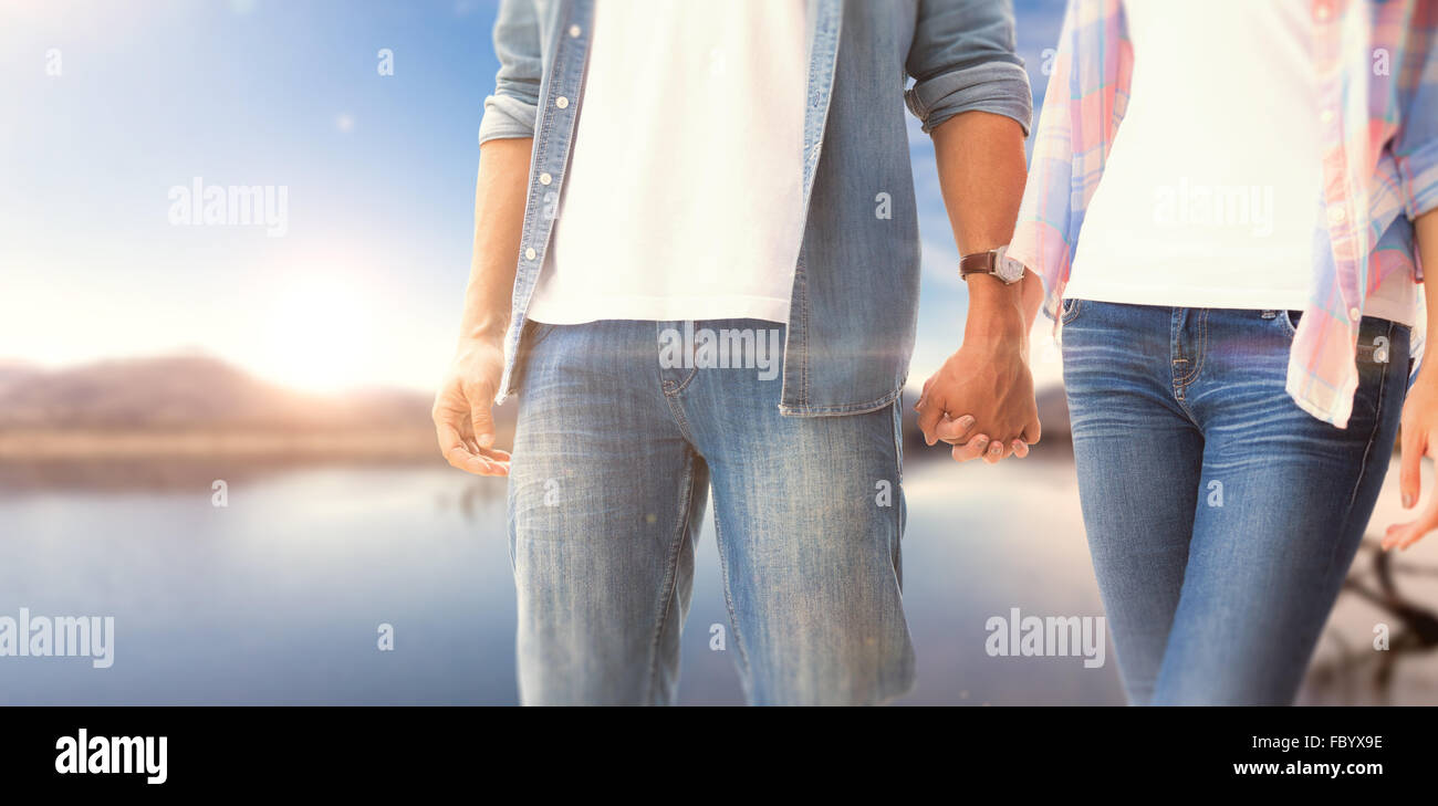 Composite image of hip young couple holding hands Stock Photo - Alamy