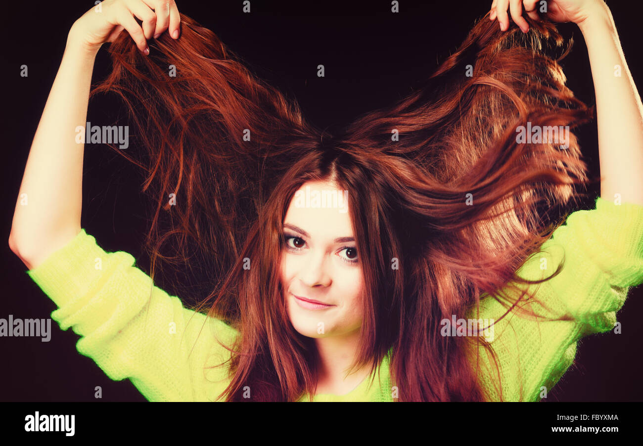 Young woman pulling her long hair Stock Photo - Alamy