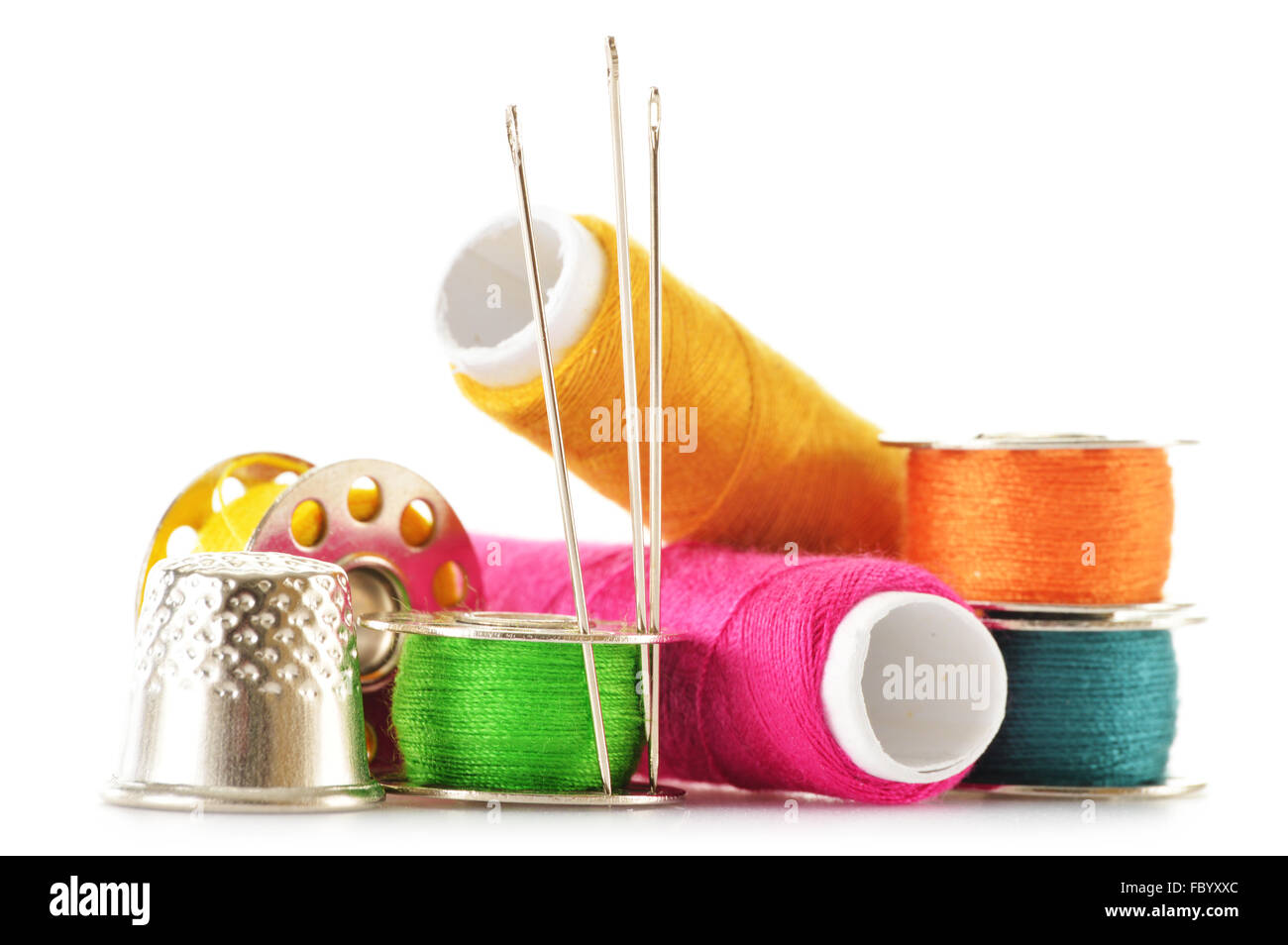 Tailor needles and threads over white background Stock Photo - Alamy