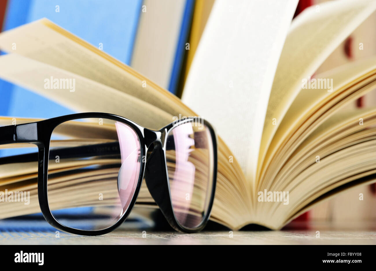 Composition with glasses and books on the table Stock Photo - Alamy
