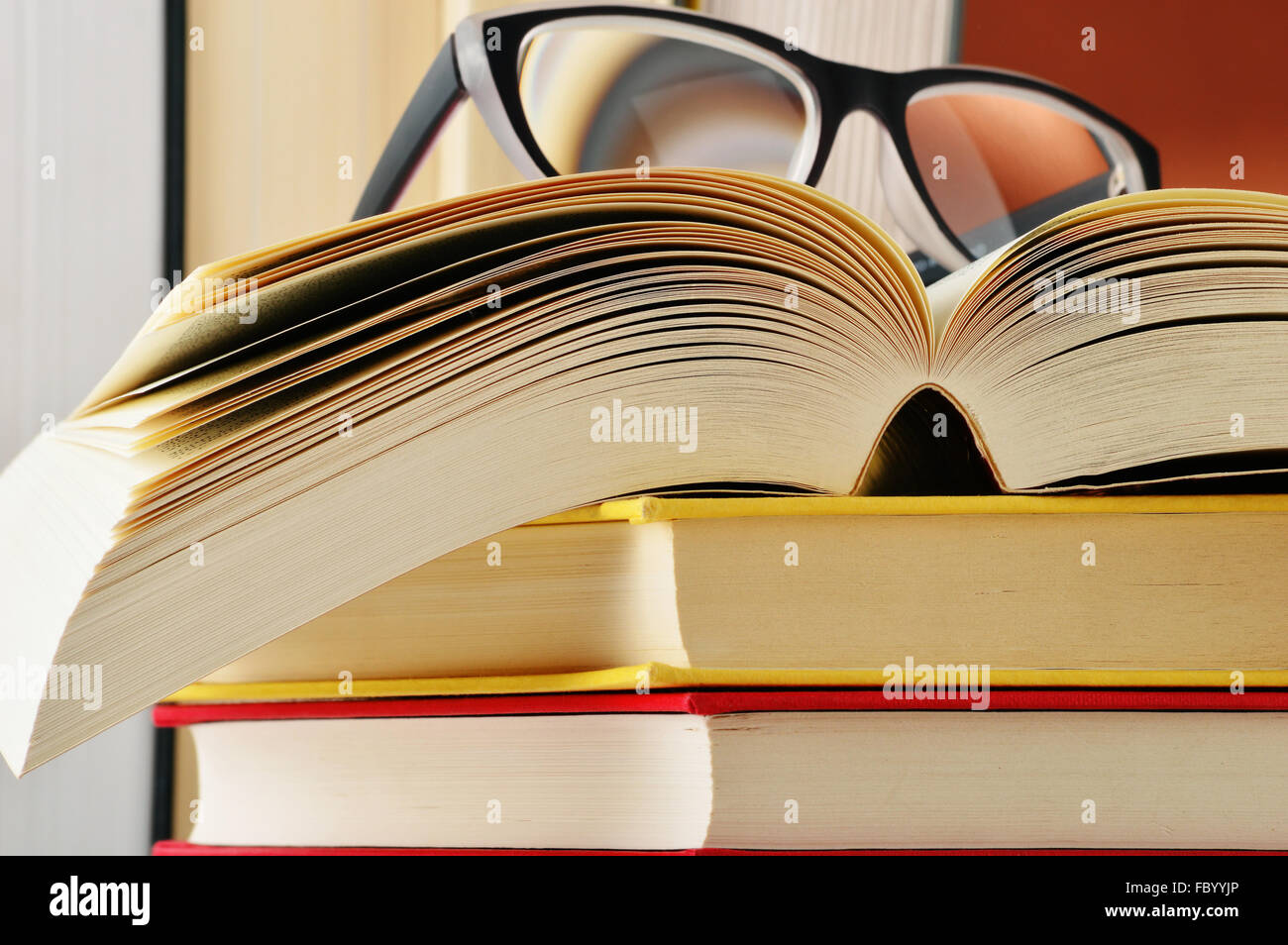 Composition with glasses and books on the table Stock Photo - Alamy