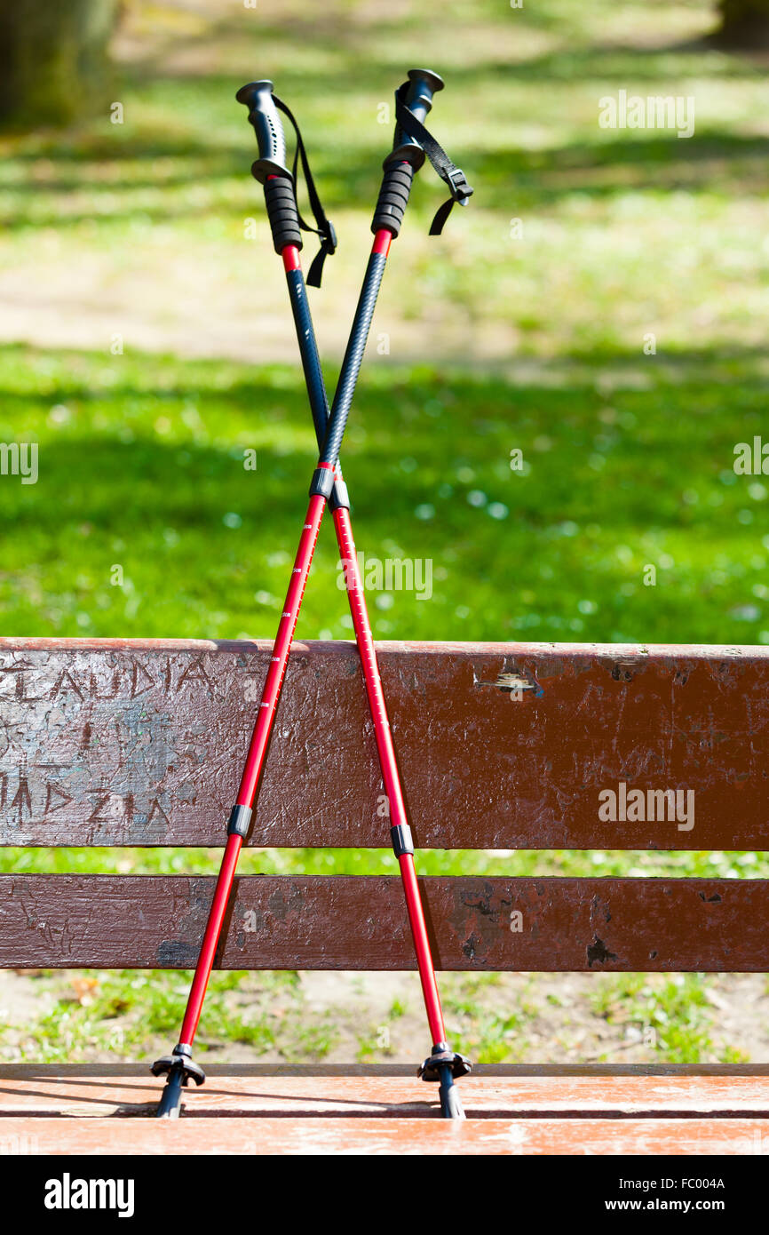 Nordic walking equipment on the park bench Stock Photo - Alamy