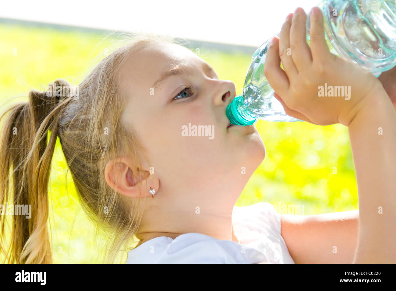 Cute girl drinking water Stock Photo - Alamy