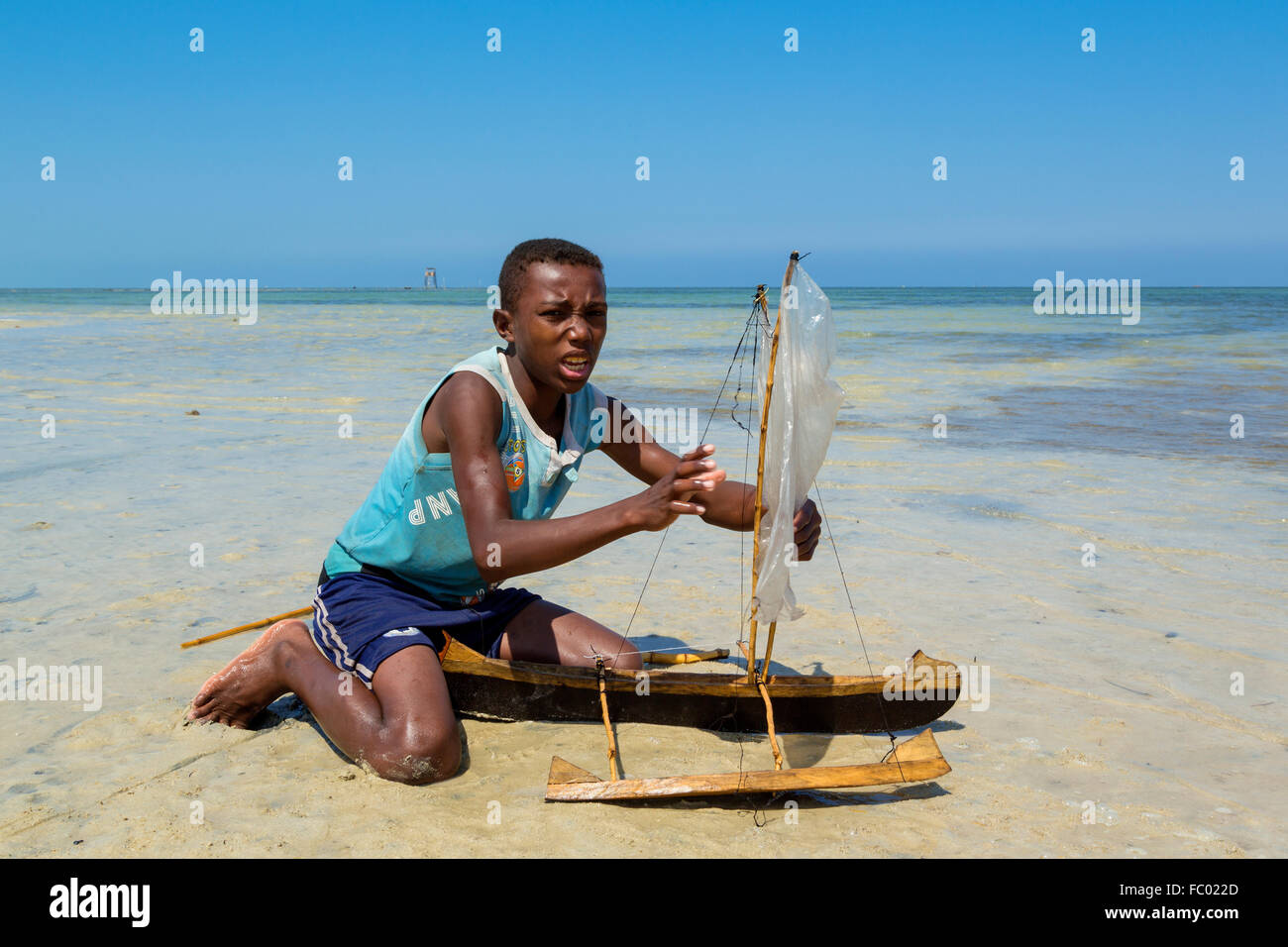 Young people playing with a pirogue model,Fishing harbour at Ifaty ...