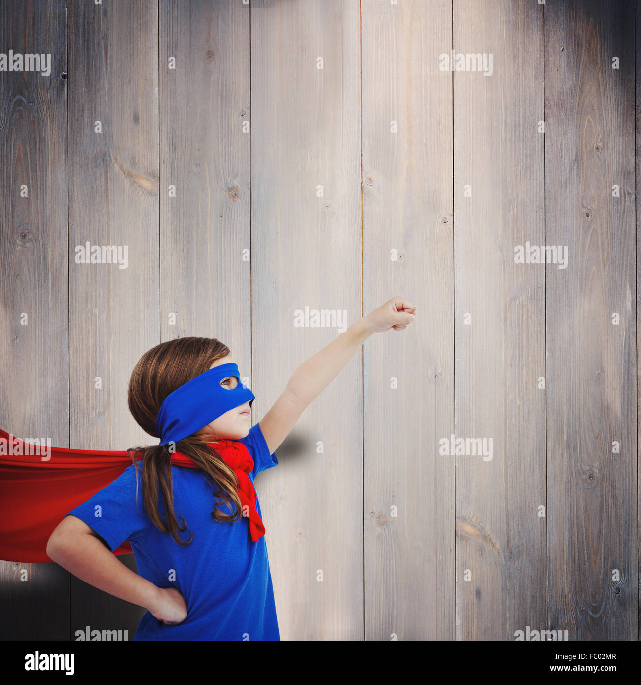 Composite image of masked girl pretending to be superhero Stock Photo ...