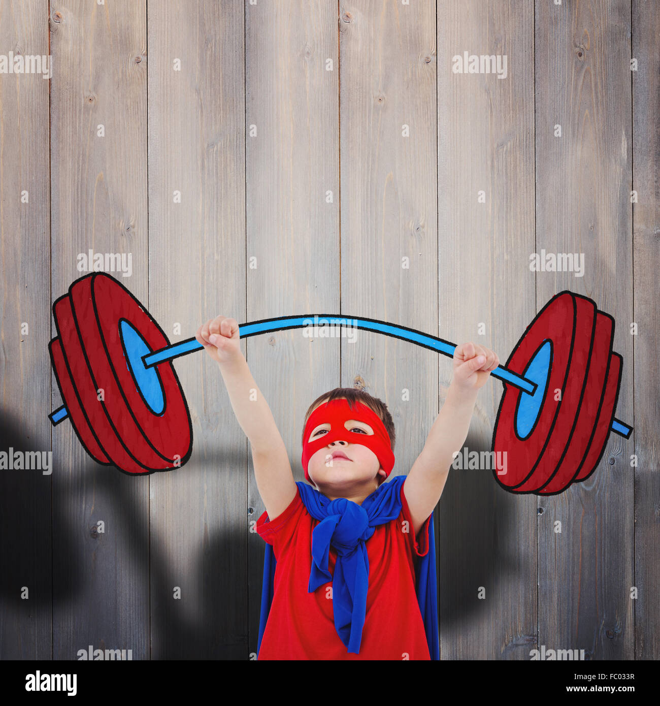 Composite image of little boy holding dumbbell Stock Photo - Alamy