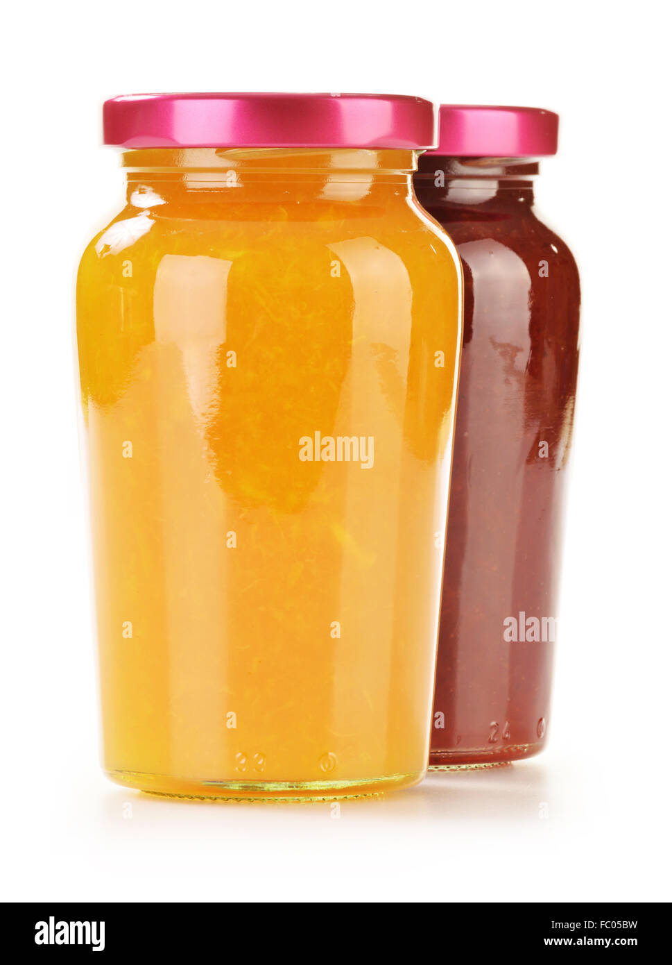 Two jars of fruity jams isolated on white background. Preserved fruits ...