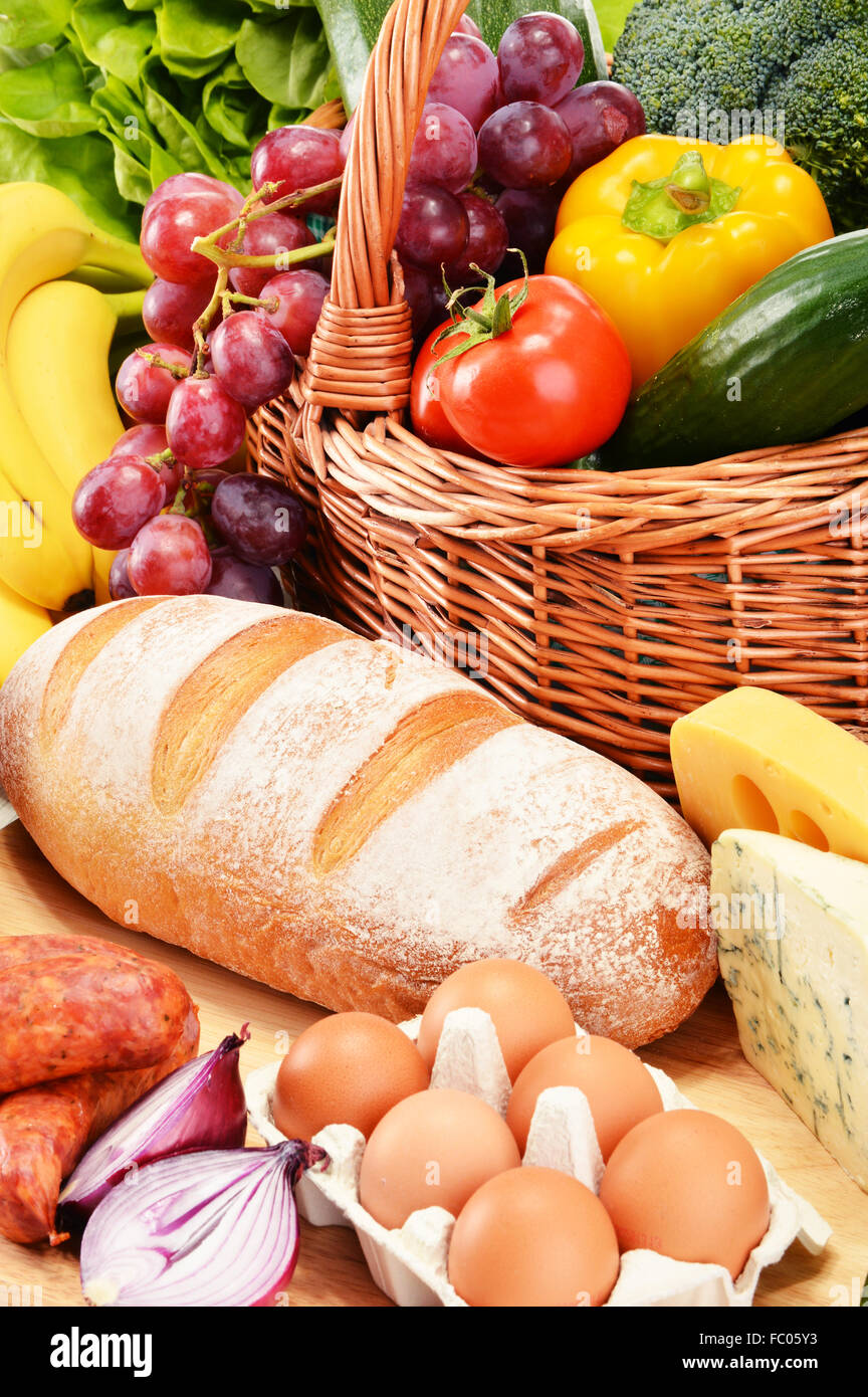 Assorted grocery products including vegetables fruits wine bread dairy ...