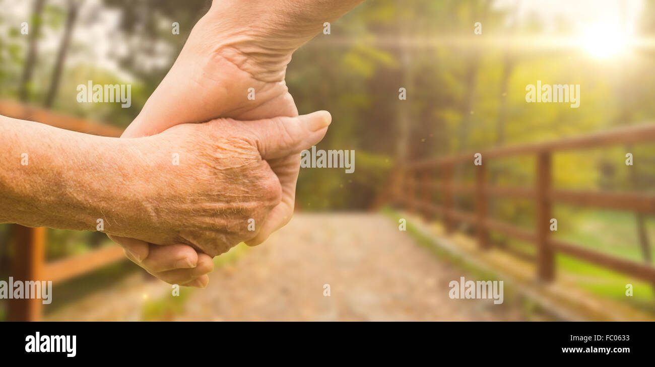 Composite image of elderly couple holding hands Stock Photo - Alamy