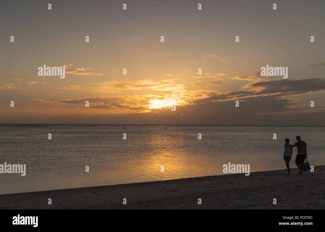 A walk on the beach in Mauritius at sunset Stock Photo - Alamy