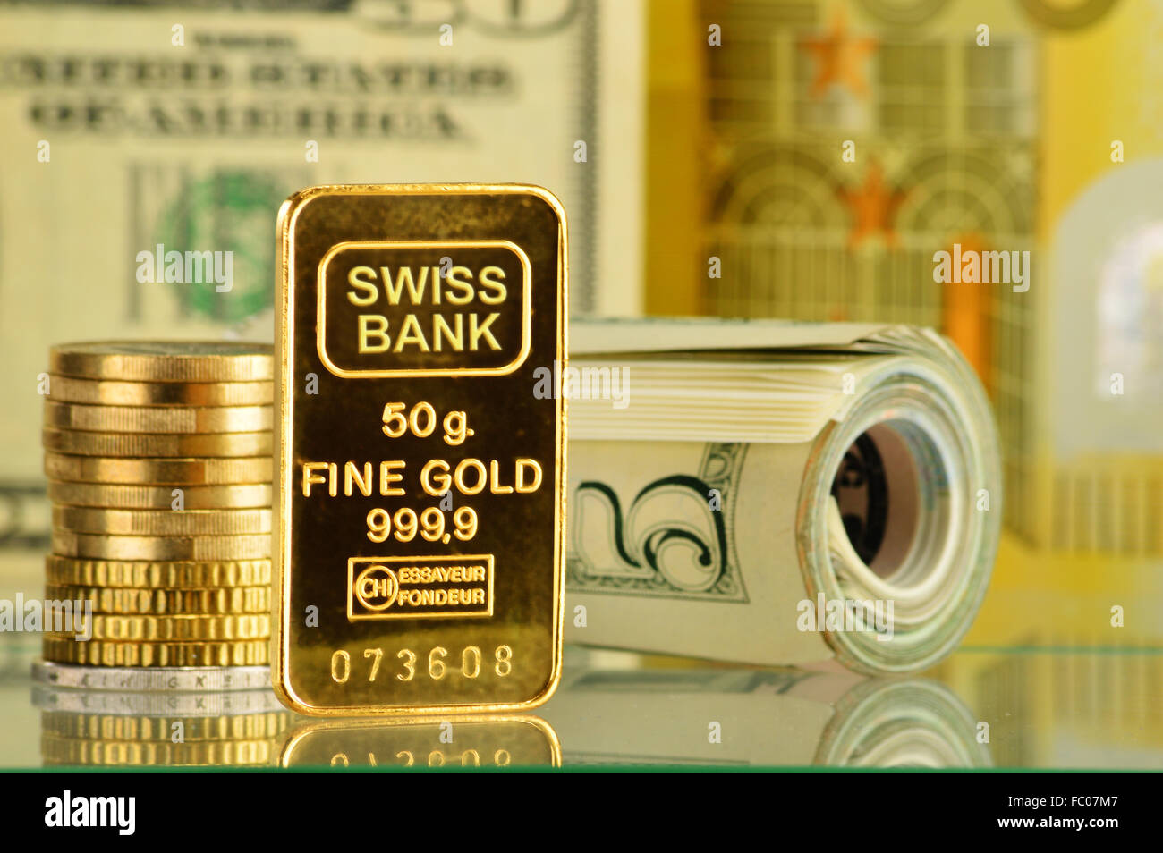 Composition with 50 gram gold bar, banknotes and coins Stock Photo - Alamy