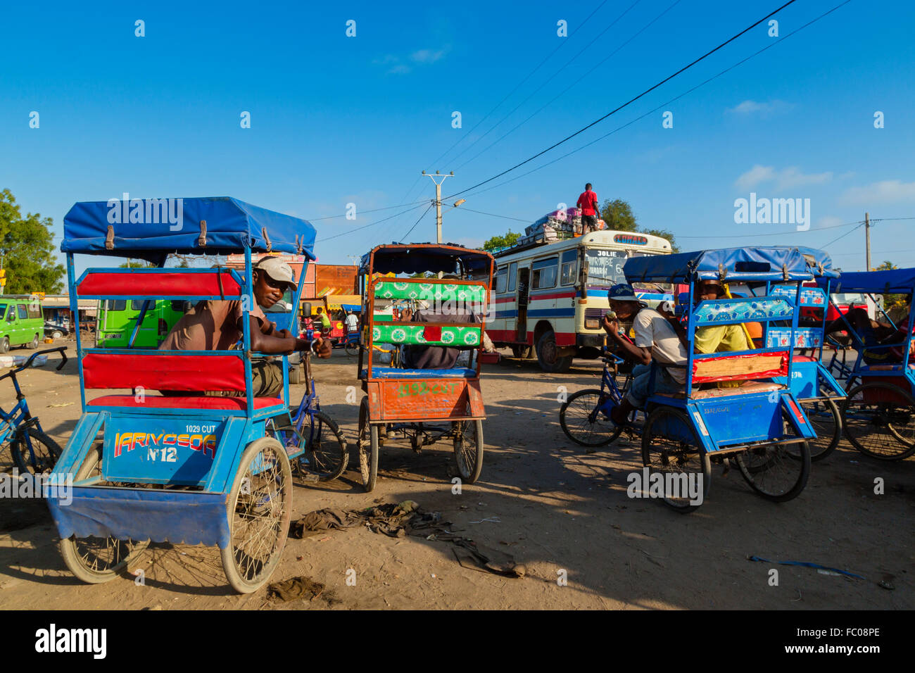 Road National 7, bush taxi station and rickshaws, Tulear, Madagascar ...