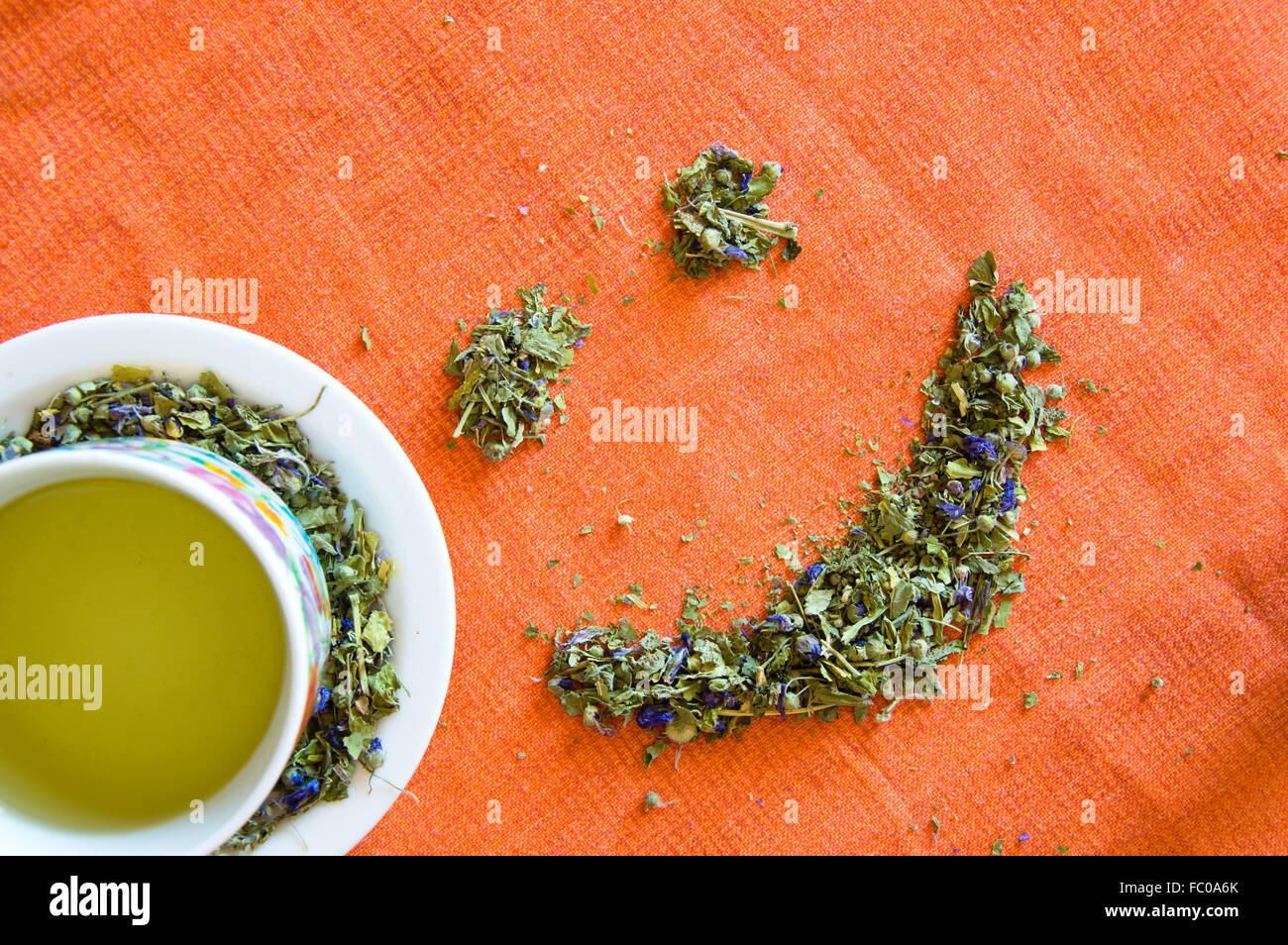 Mallow herbal tea cup on orange background with happy smile Stock Photo ...