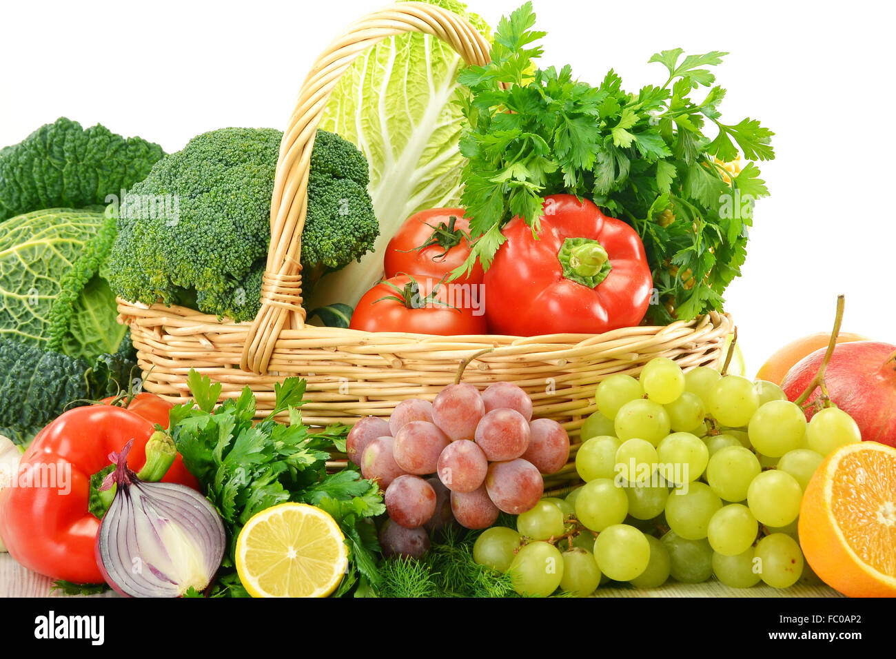 Composition with vegetables and fruits in wicker basket isolated Stock ...