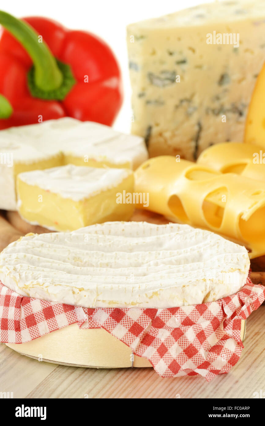 Composition with pieces of cheese on breadboard Stock Photo - Alamy