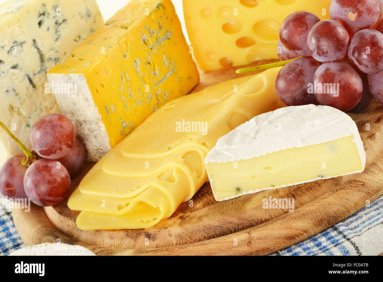 Composition with pieces of cheese on breadboard Stock Photo - Alamy