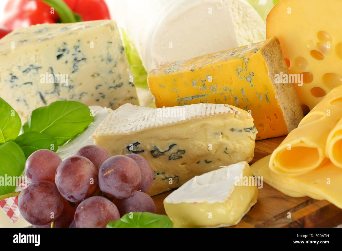 Composition with pieces of cheese on breadboard Stock Photo - Alamy