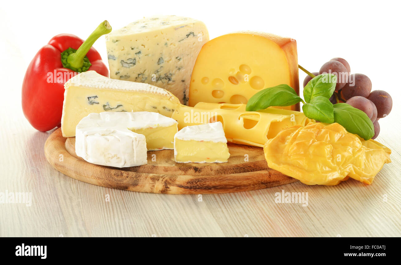 Composition with pieces of cheese on breadboard Stock Photo - Alamy
