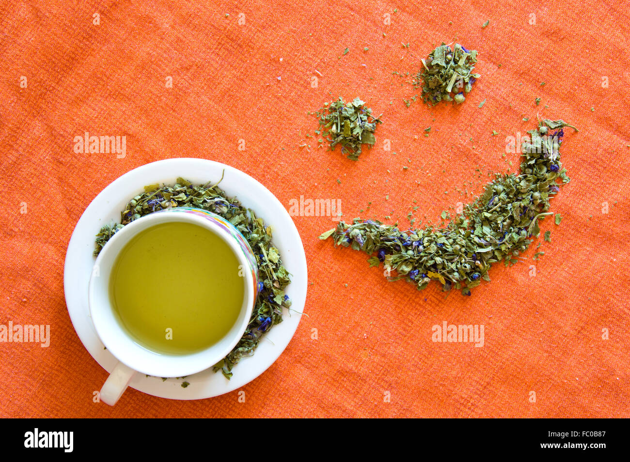 Mallow herbal tea cup on orange background with happy smile Stock Photo ...